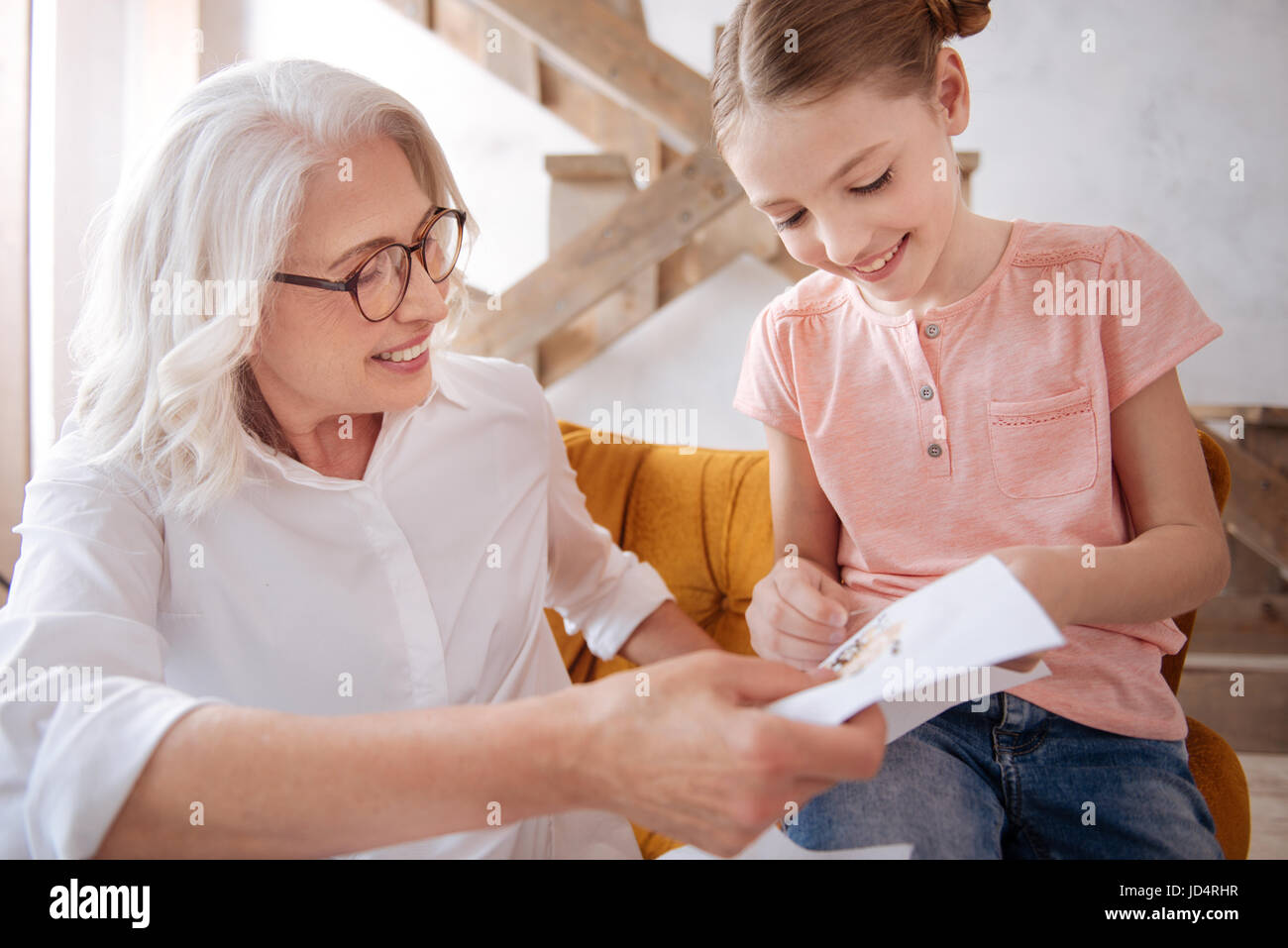 Cute cheerful girl doing the embroidery Stock Photo - Alamy
