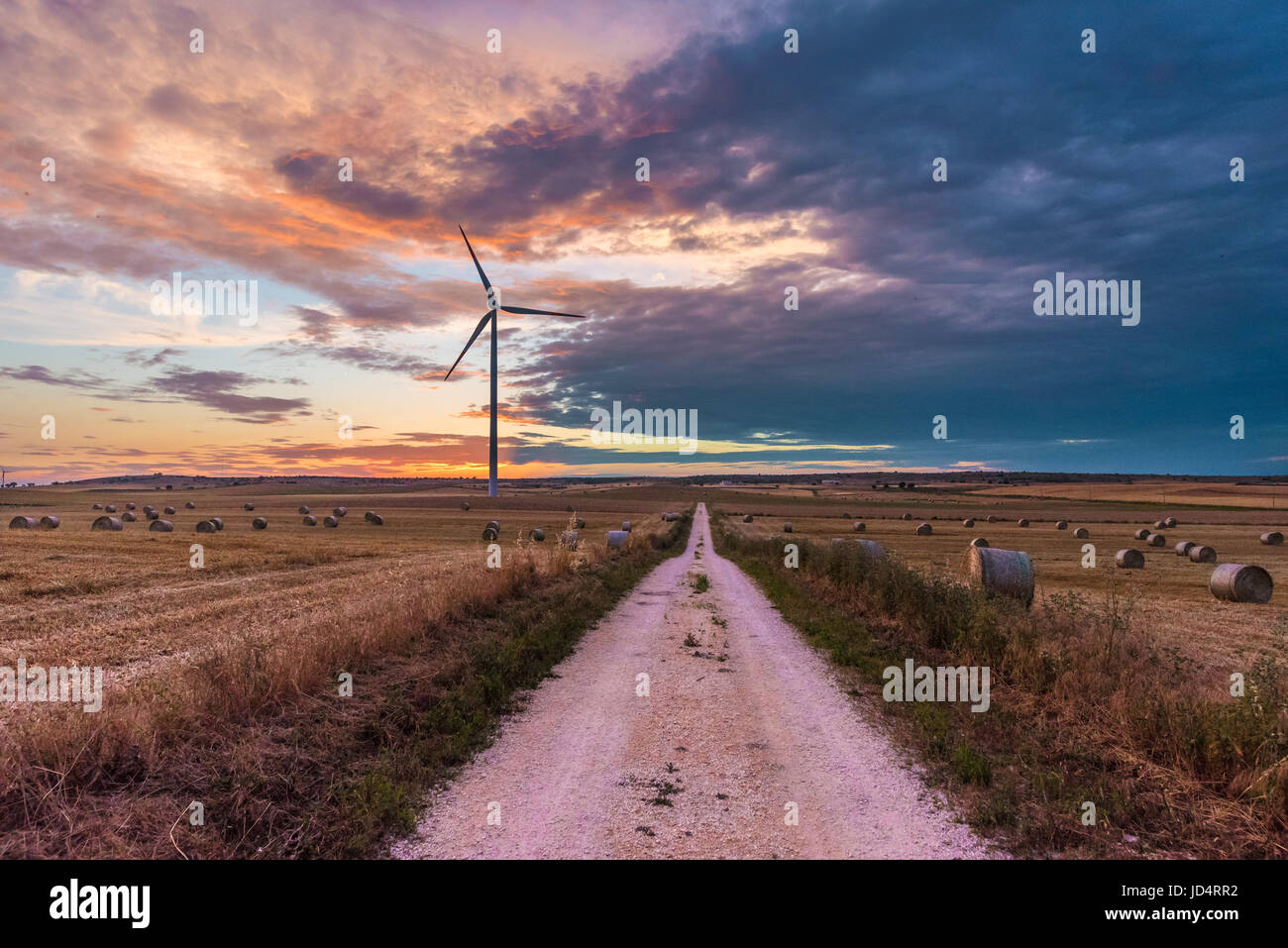 Puglia (Italy) - Wind farm with rock ruins, wind turbines and bales of ...