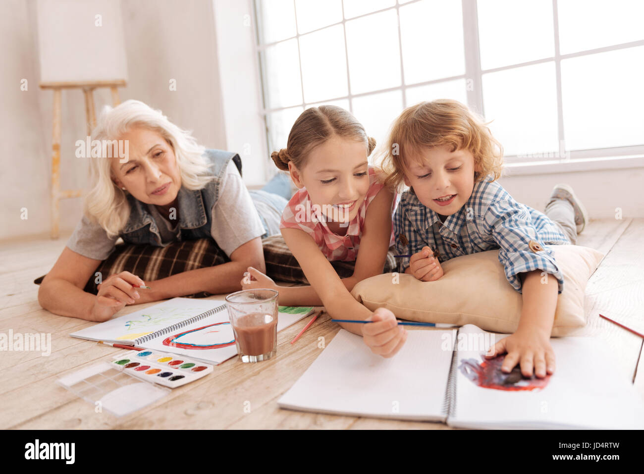 Positive creative children having an art lesson Stock Photo - Alamy