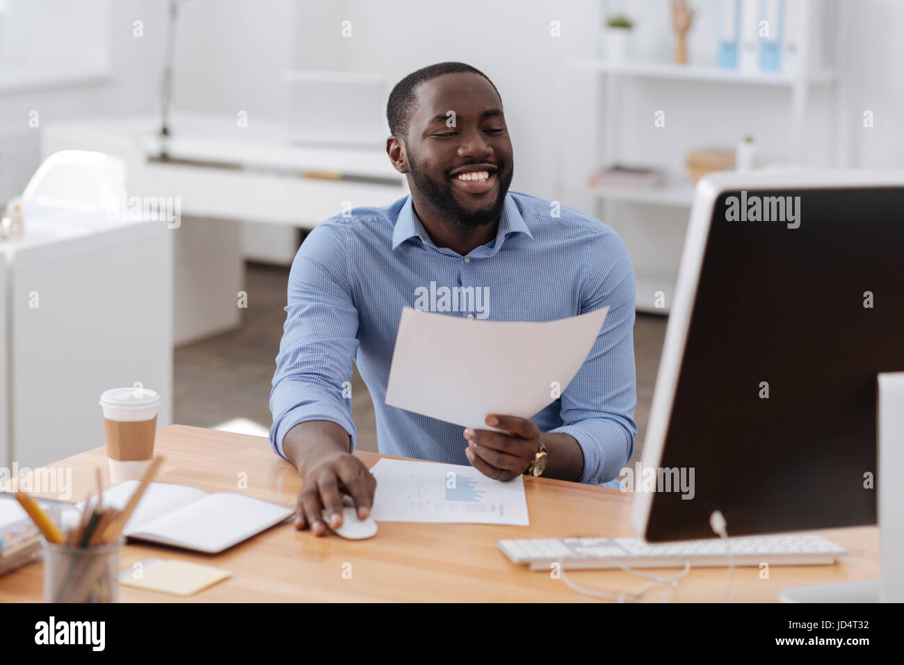 Positive happy man holding a computer mouse Stock Photo - Alamy