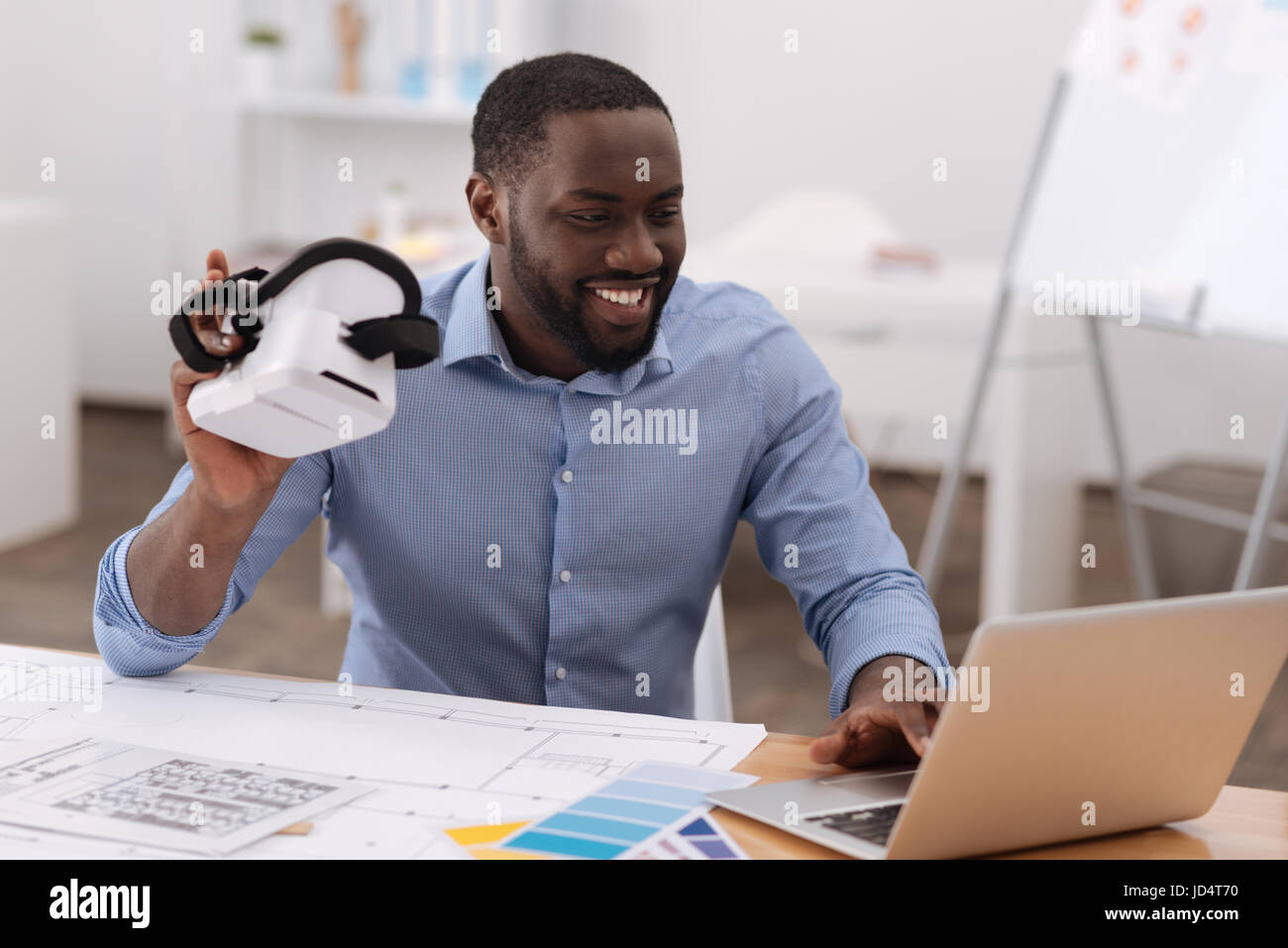 Joyful handsome man looking at the laptop screen Stock Photo - Alamy