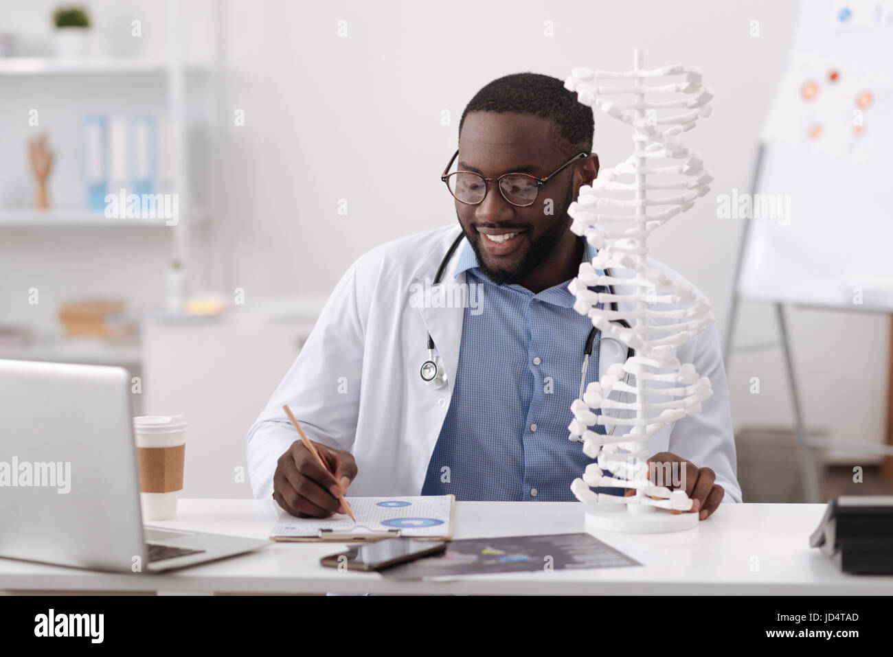 Intelligent smart scientist taking notes Stock Photo - Alamy