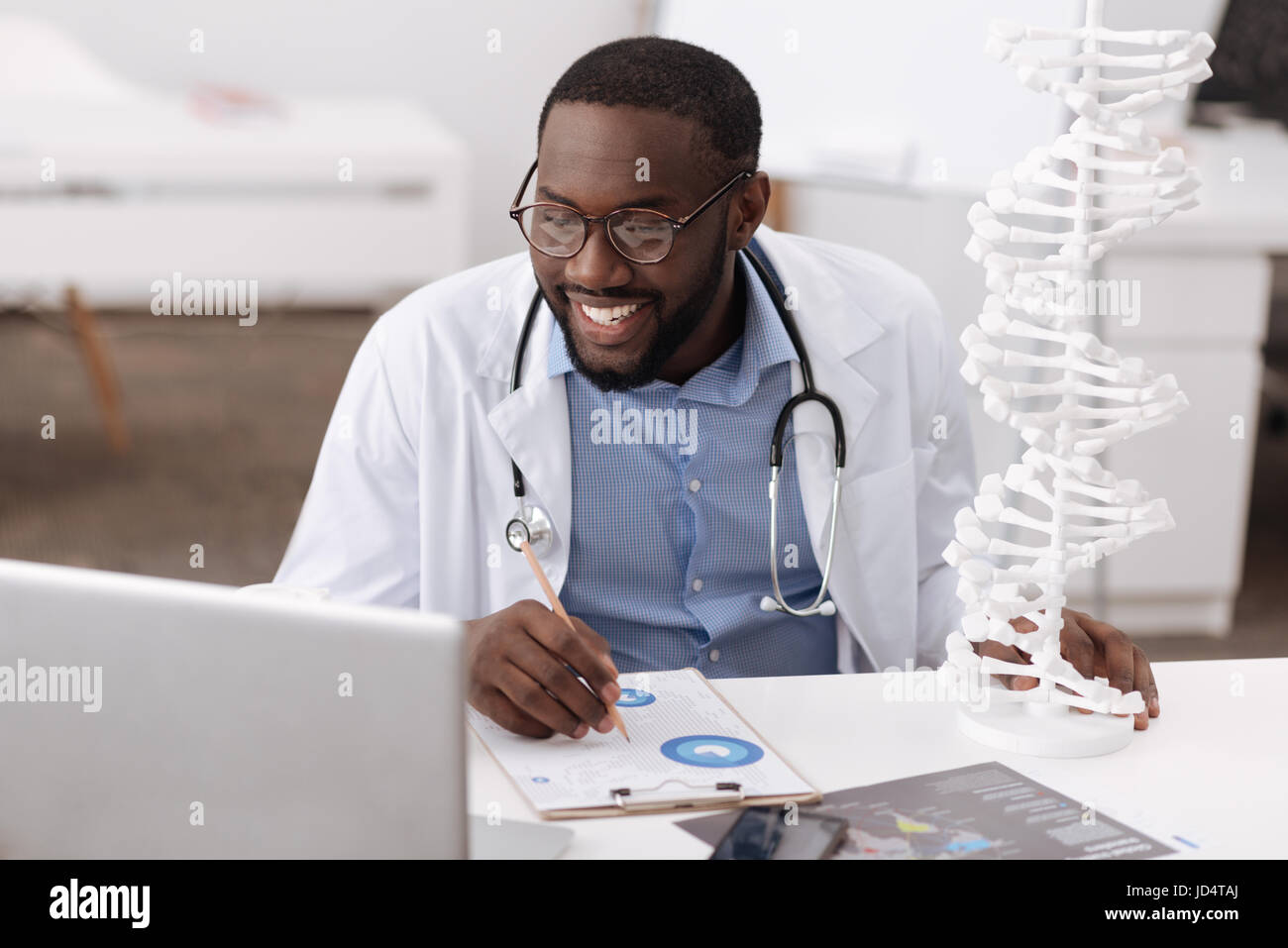Cheerful professional scientist doing a research Stock Photo - Alamy