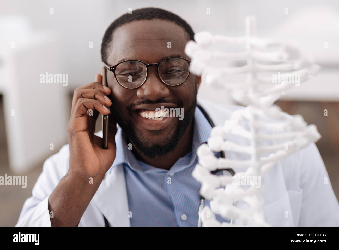 Cheerful nice scientist speaking on the phone Stock Photo - Alamy