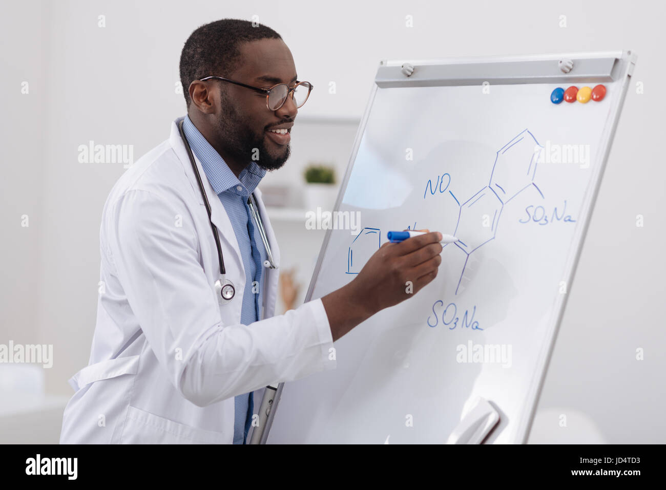 Smart cheerful scientist writing on the whiteboard Stock Photo - Alamy