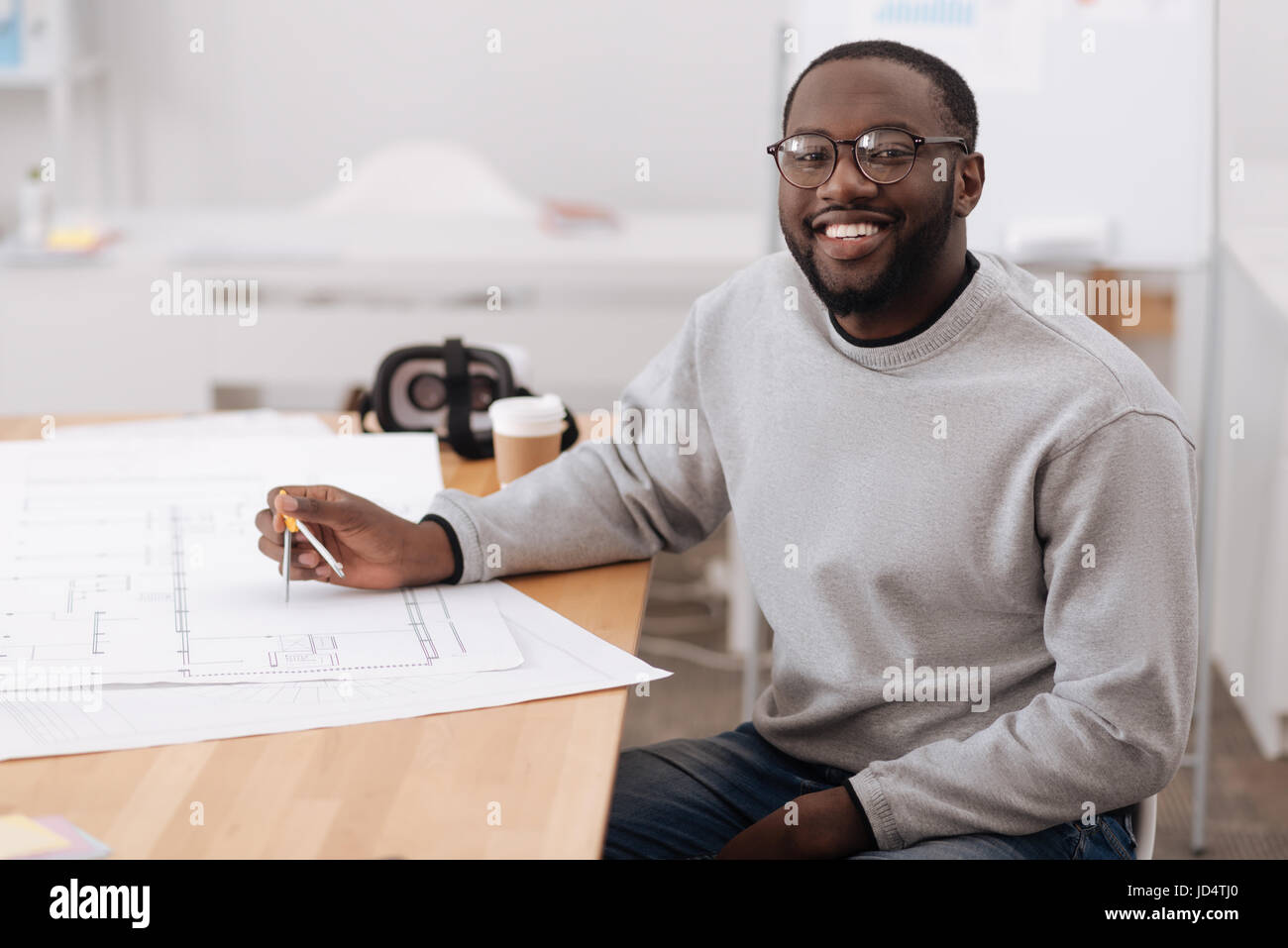 Joyful male engineer working on a drawing Stock Photo - Alamy