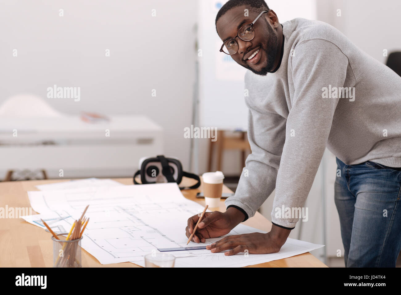 Positive handsome man leaning over the table Stock Photo - Alamy