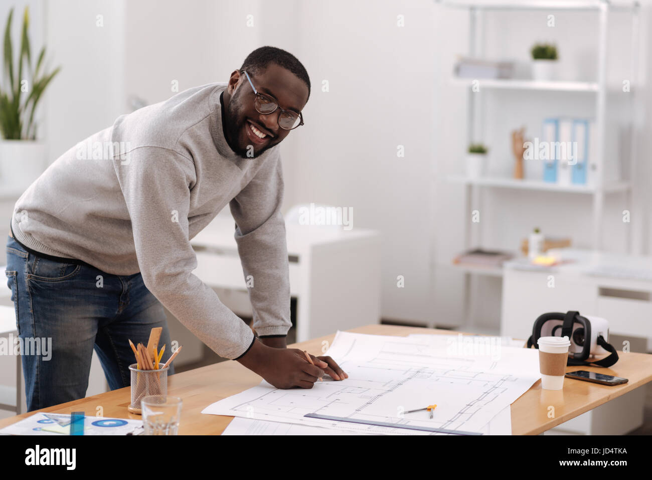 Cheerful positive engineer designing a building Stock Photo - Alamy