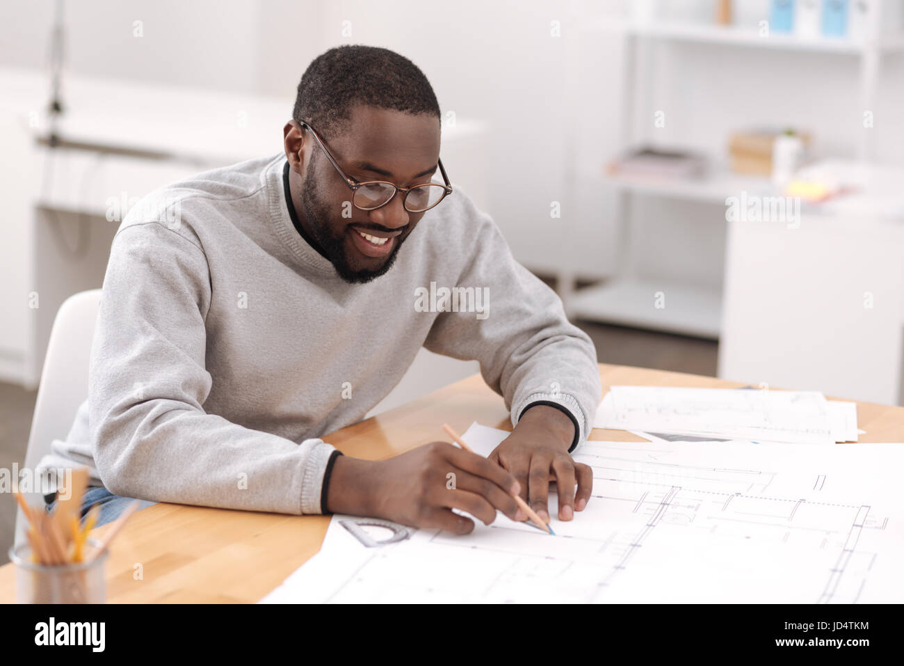 Joyful hard working engineer focusing on his work Stock Photo - Alamy