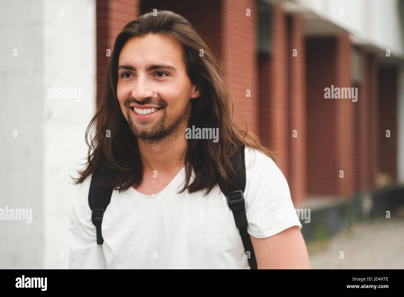 Stylish hipster model with long hair lifestyle in the street. Dressed ...