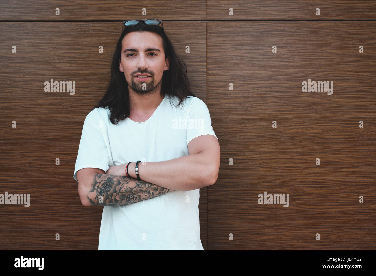Stylish hipster model with long hair lifestyle in the street. Dressed ...