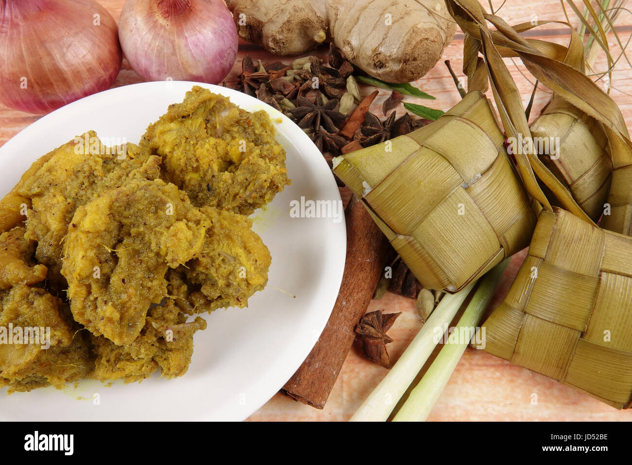 Malaysian dish Rendang Ayam or dry curry chicken and Ketupat Nasi (Rice ...