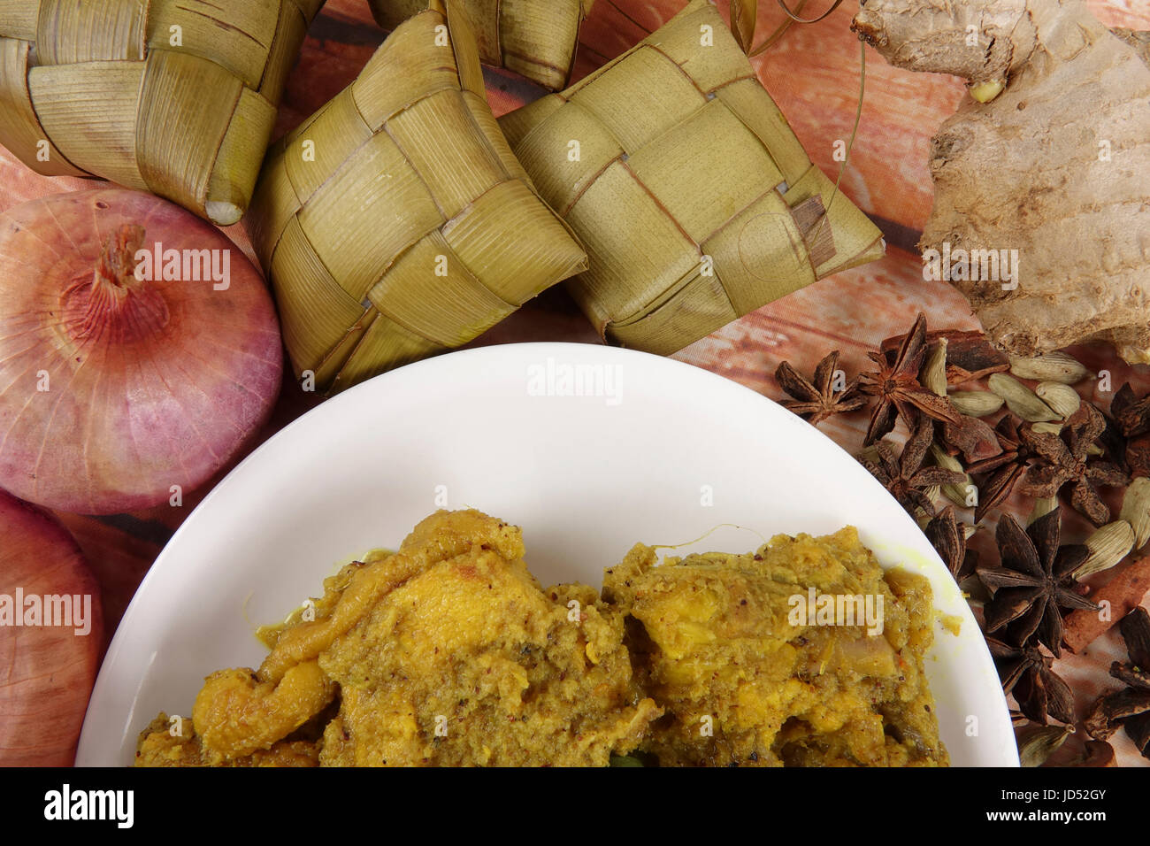 Malaysian dish Rendang Ayam or dry curry chicken and Ketupat Nasi (Rice ...