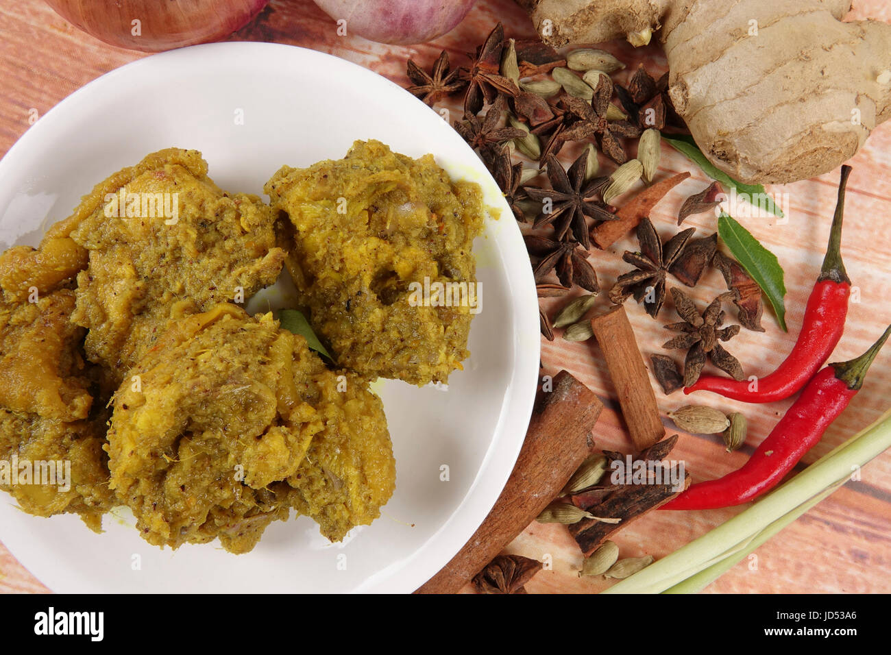 Malaysian dish Rendang Ayam or dry curry chicken and Ketupat Nasi (Rice ...