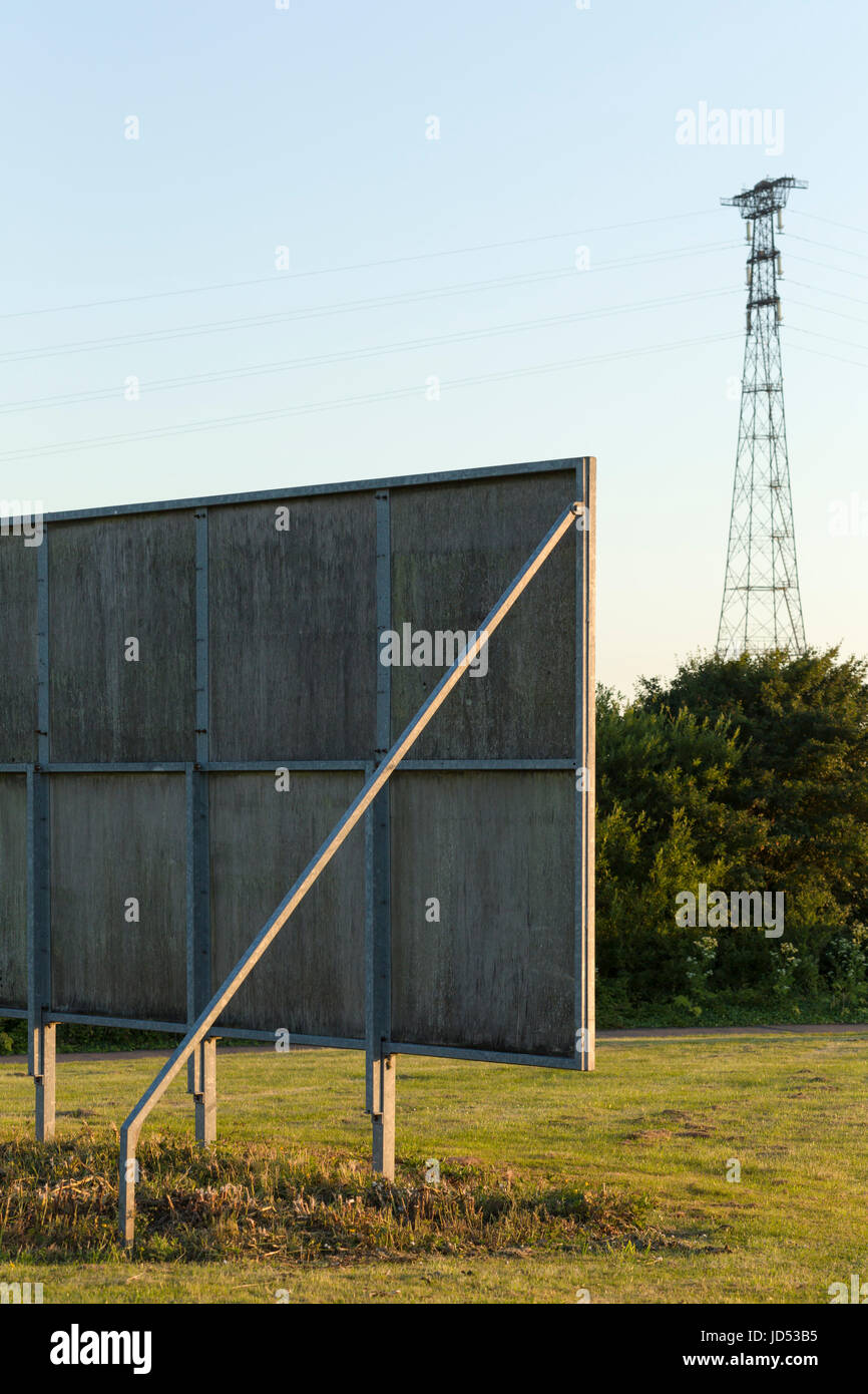 A large billboard viewed from behind in evening light with electricity ...