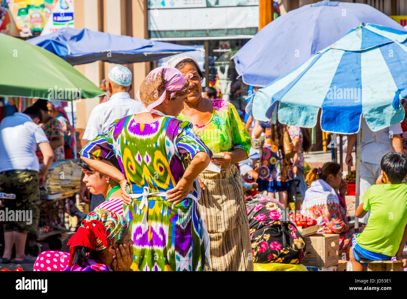 SAMARKAND, UZBEKISTAN - AUGUST 28: Two women dressed in traditional ...