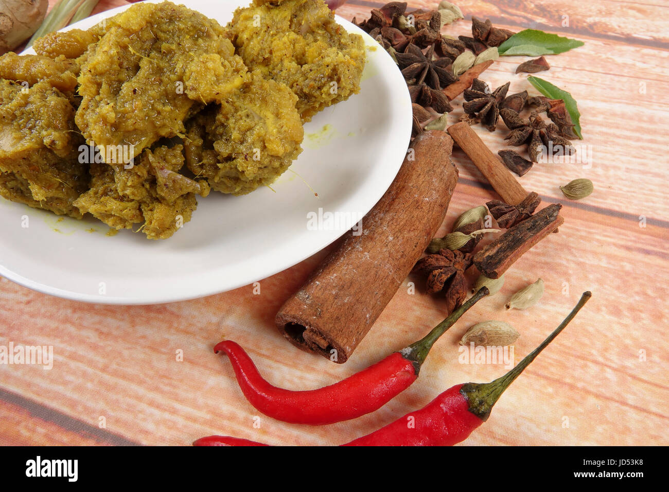 Malaysian dish Rendang Ayam or dry curry chicken and Ketupat Nasi (Rice ...