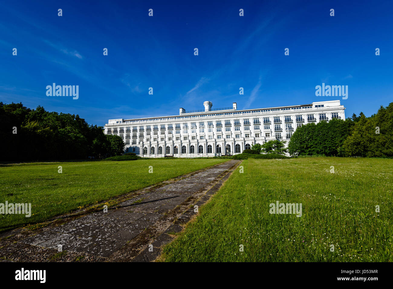 green park with walkways and large white hotel building Stock Photo - Alamy