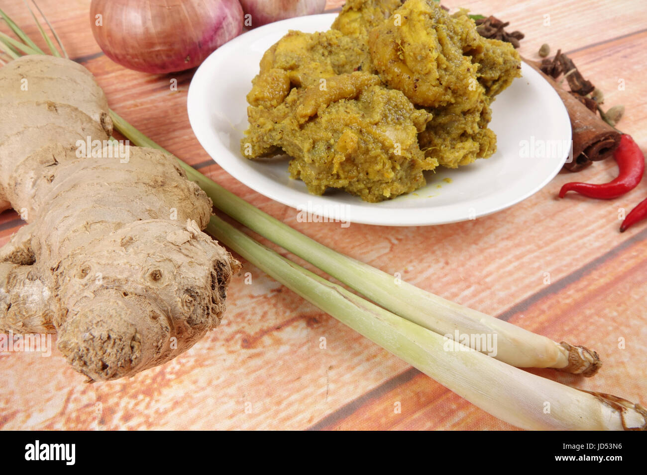 Malaysian dish Rendang Ayam or dry curry chicken and Ketupat Nasi (Rice ...