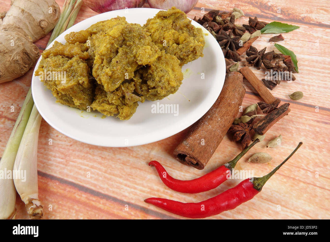 Malaysian dish Rendang Ayam or dry curry chicken and Ketupat Nasi (Rice ...