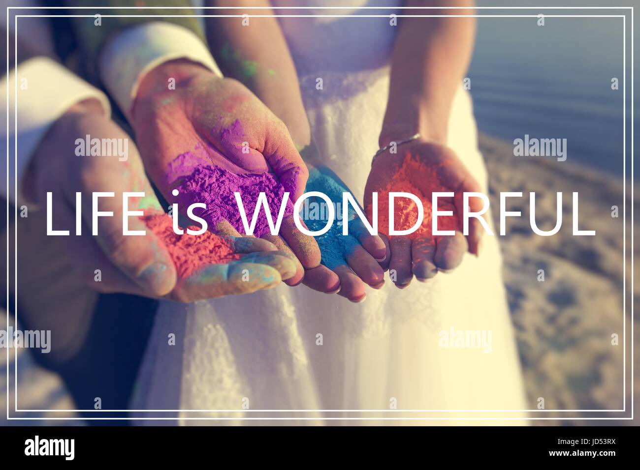 Life is Wonderful over hands with many colours Stock Photo - Alamy