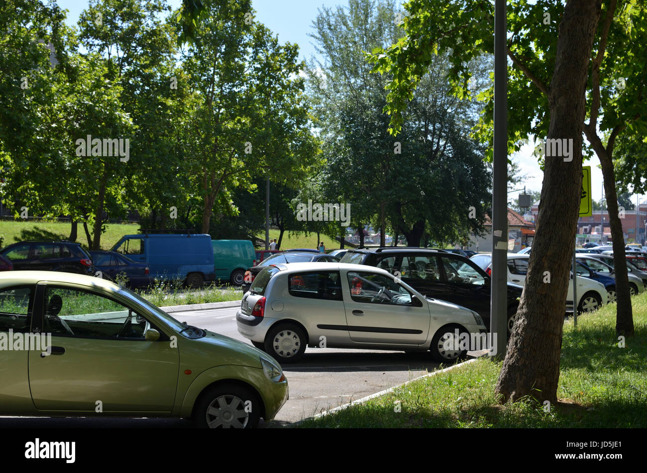 Parked cars with a free parking place on the street in residential area ...