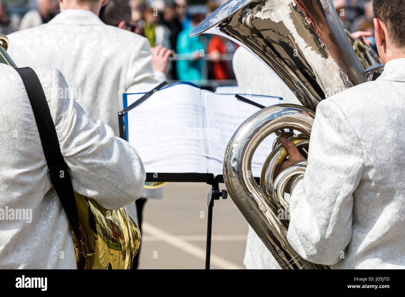orchestra musicians playing big bass tubas. musical notes on stand ...
