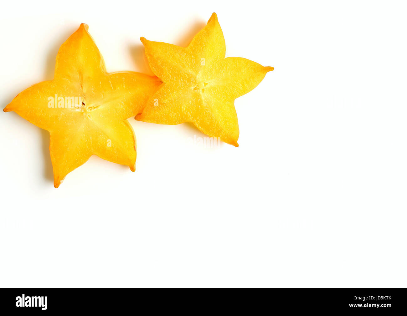 Closed up texture of two vibrant yellow sliced ripe Star Fruits on ...