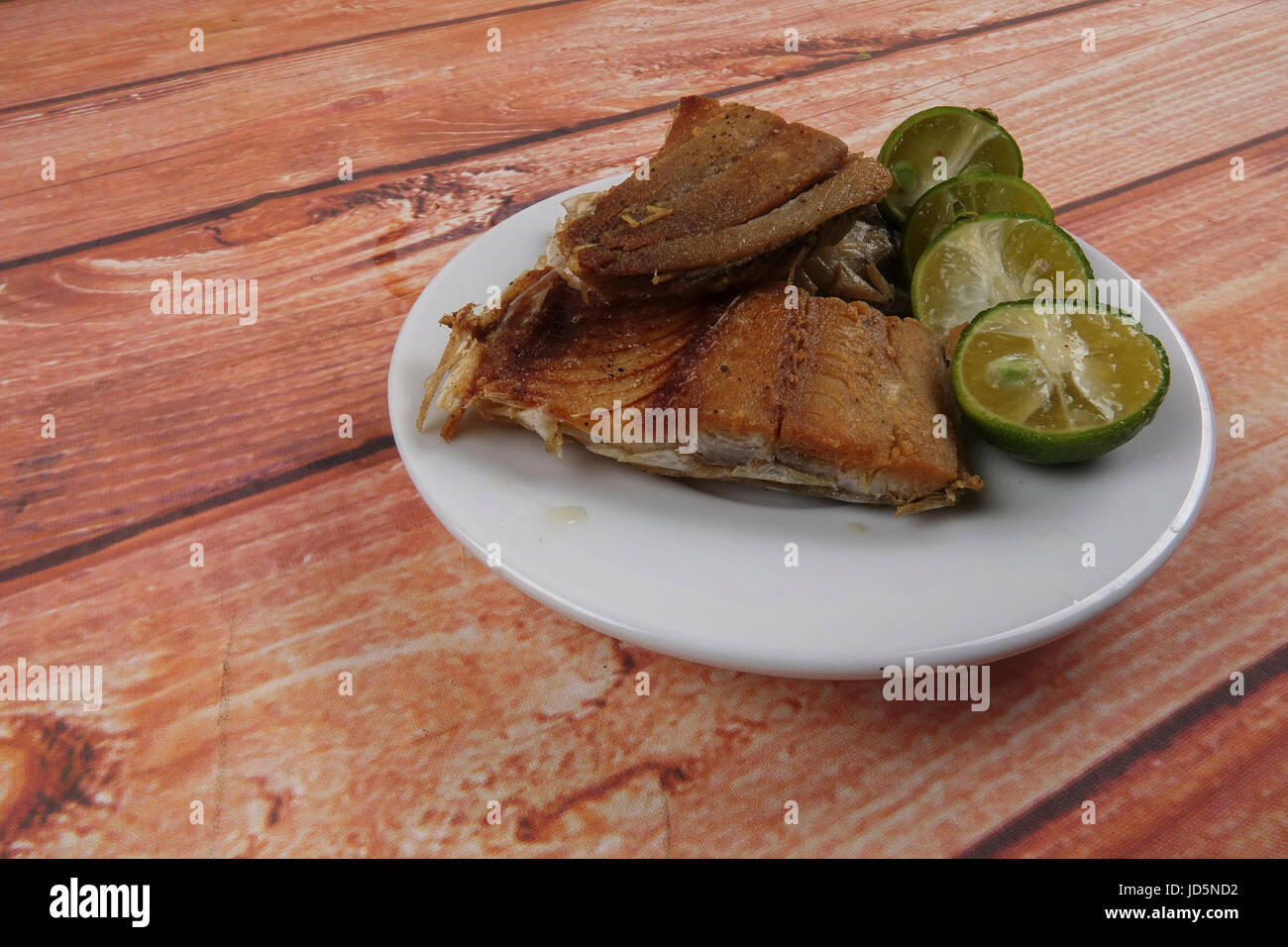 Salted fish with lime on wooden background Stock Photo - Alamy