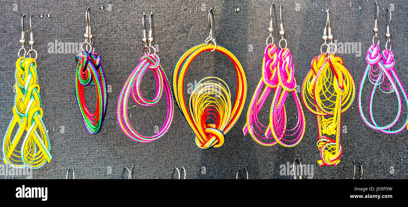 Handmade colorful of various form, decorative earrings, sold in outdoor ...