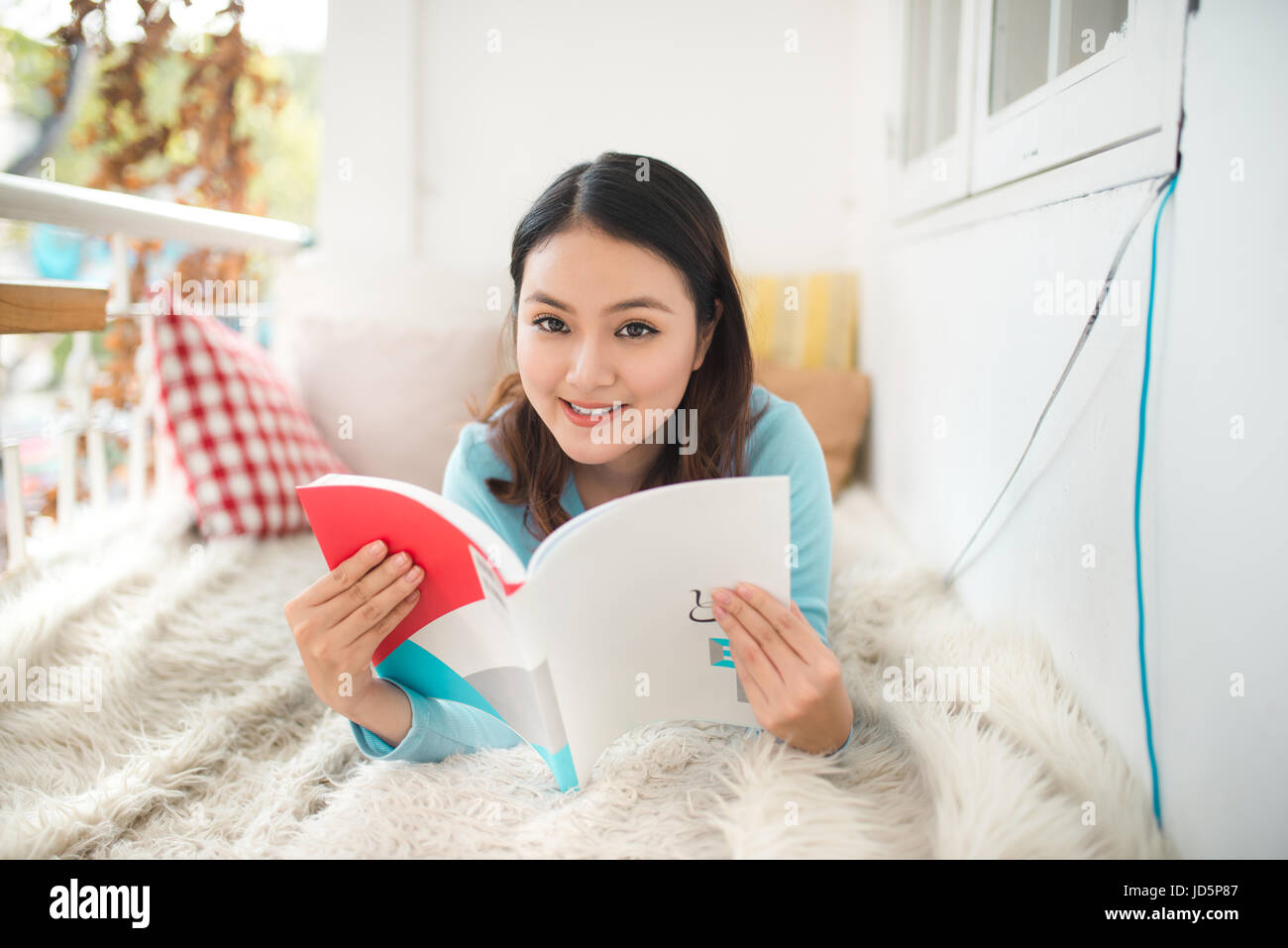 Portrait of young asian woman reading book at home Stock Photo - Alamy