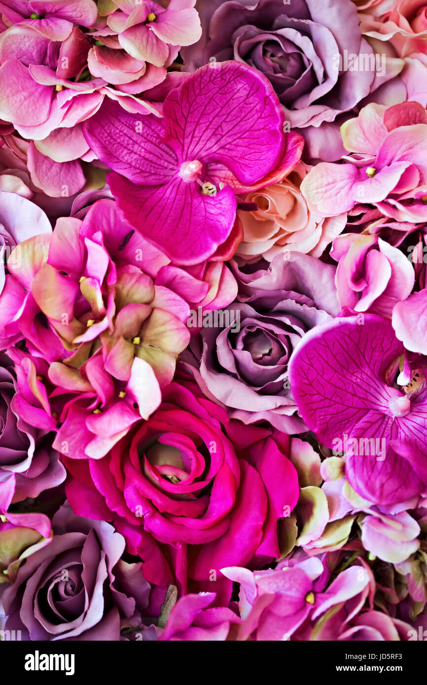 Artificial pink flowers background Stock Photo - Alamy