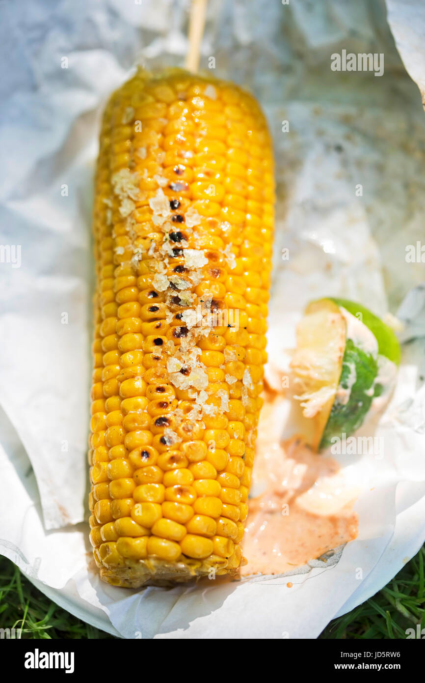 Mexican barbecued corn on the knob with Harissa mayo and lime Stock ...