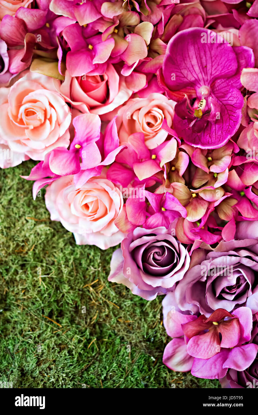 Artificial pink flowers background Stock Photo - Alamy