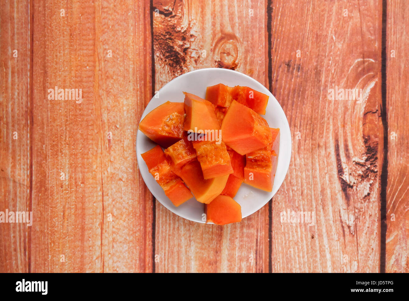 sliced of papaya on wooden background Stock Photo - Alamy