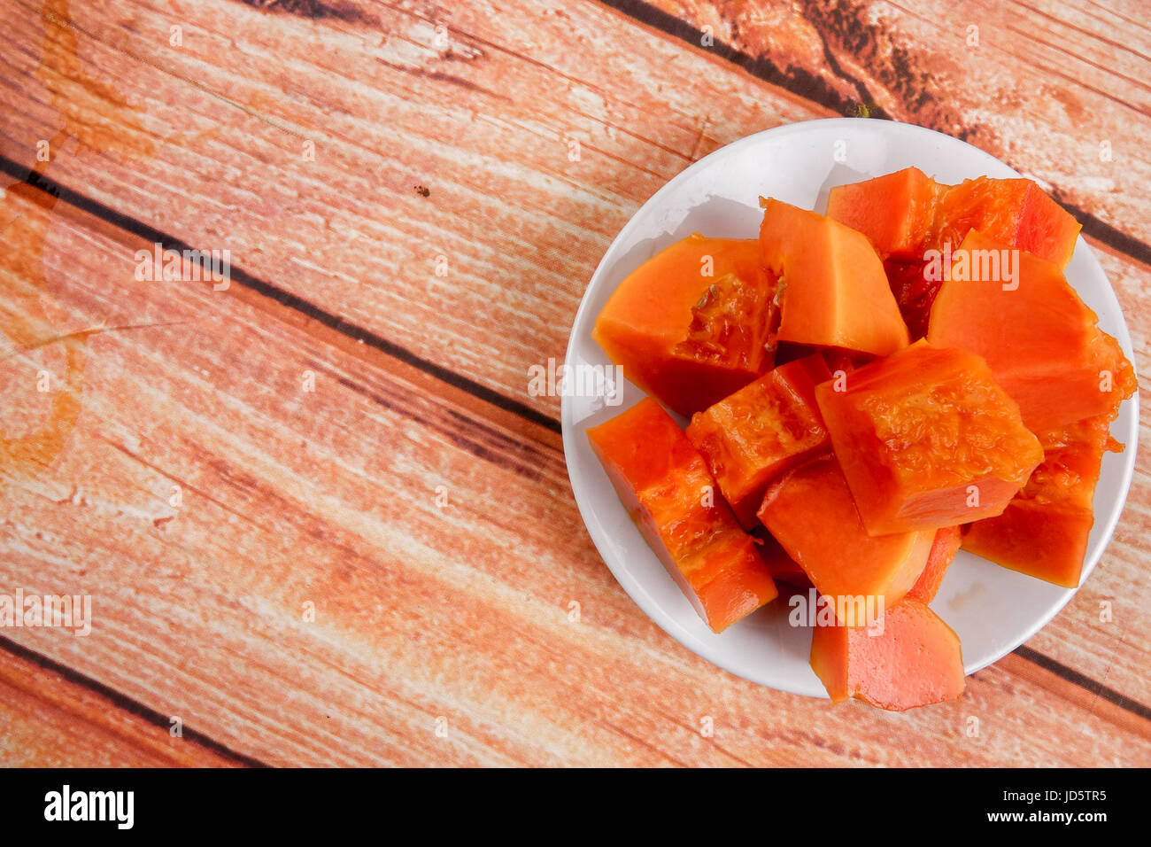 sliced of papaya on wooden background Stock Photo - Alamy