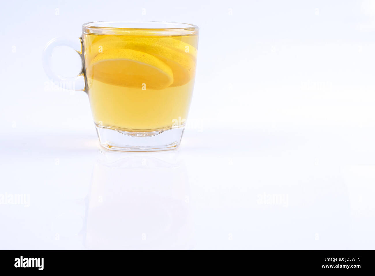 Hot lemon tea in the glass on white background Stock Photo - Alamy