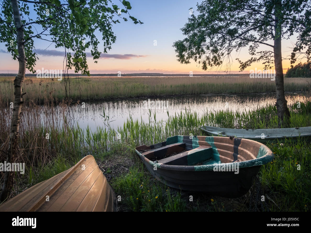 Scenic landscape with rowboats at peaceful summer evening in Hyvinkää ...