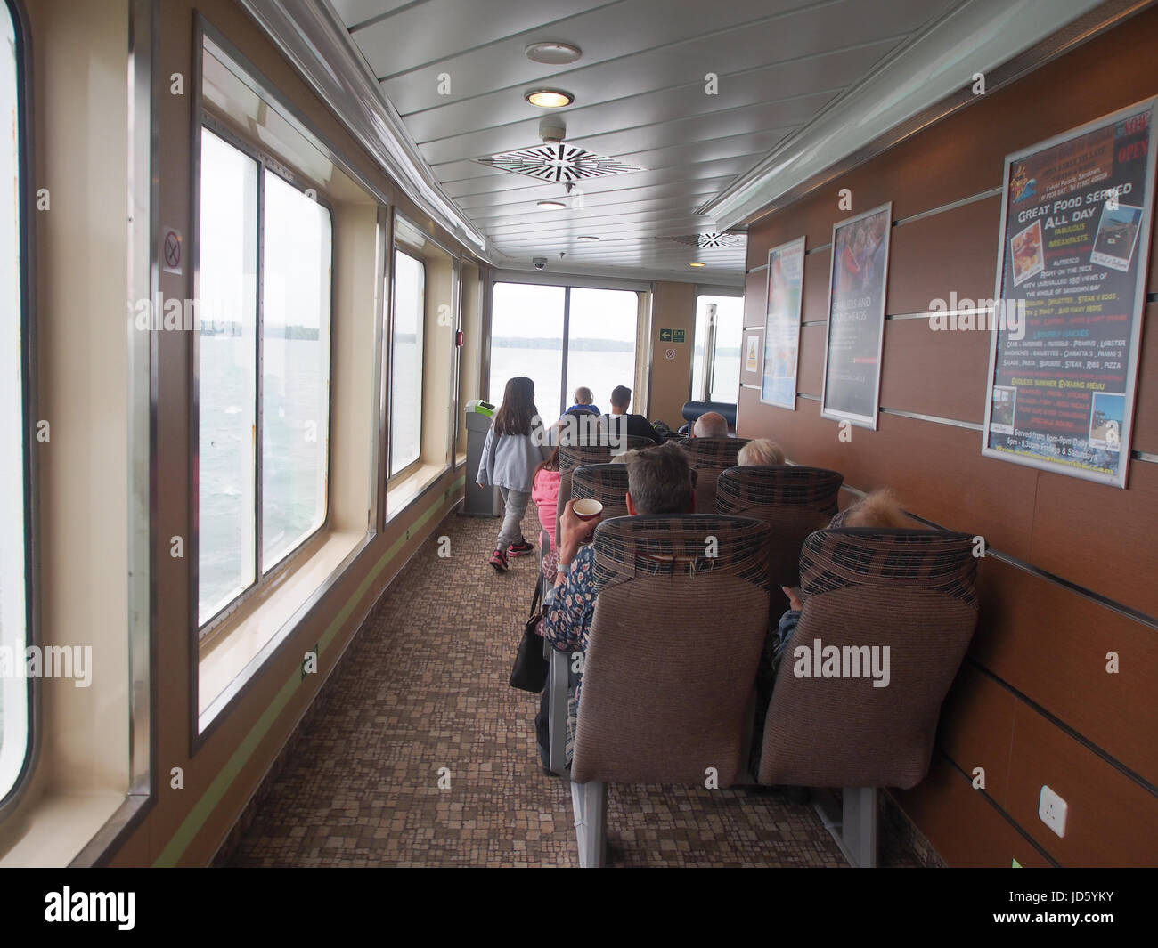 Passengers sit onboard a Wightlink car ferry during a sea crossing from ...