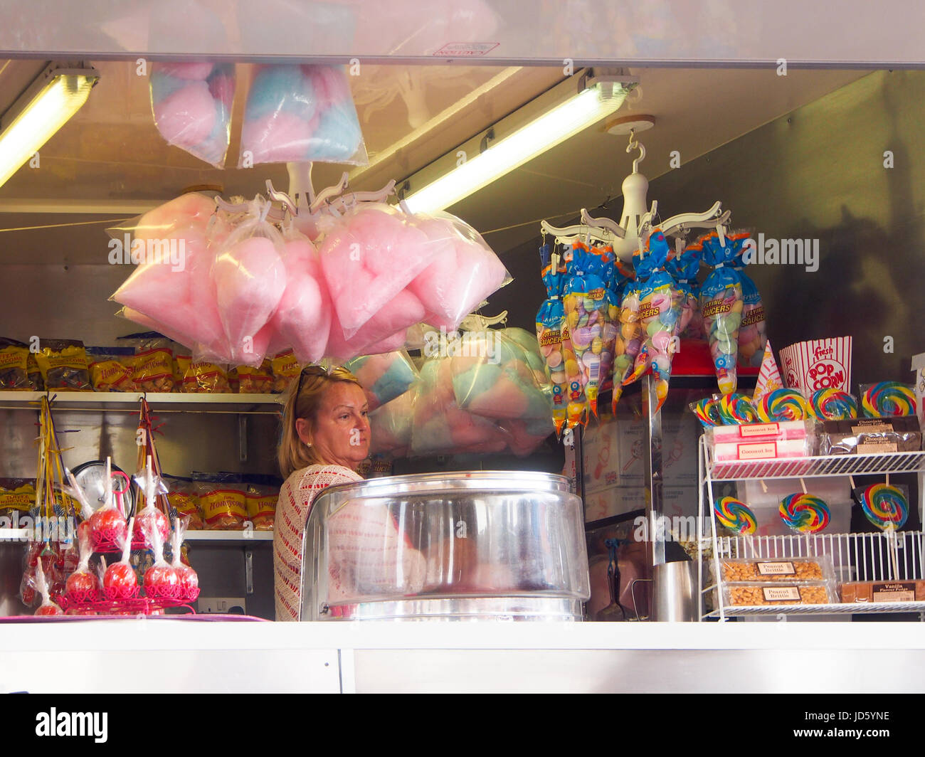 A lady sells candyfloss, sweets and cotton candy from a food van Stock ...