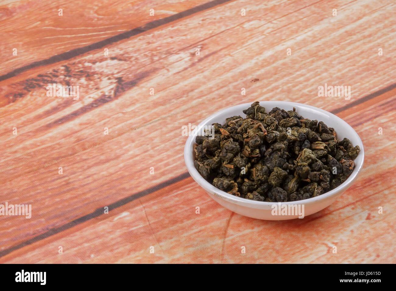 dried chinese tea leaves in a small bowl over wooden background Stock ...