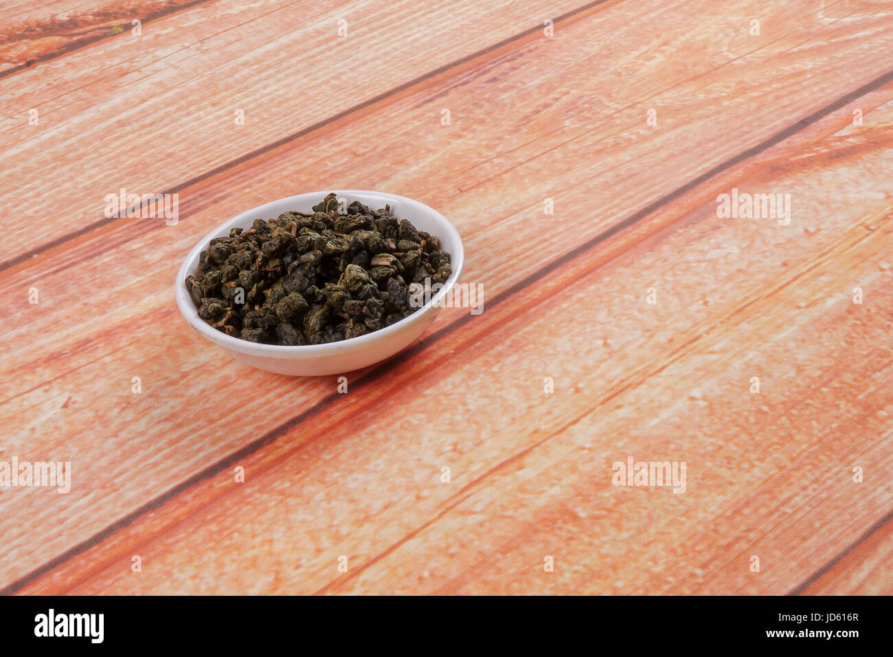 dried chinese tea leaves in a small bowl over wooden background Stock ...