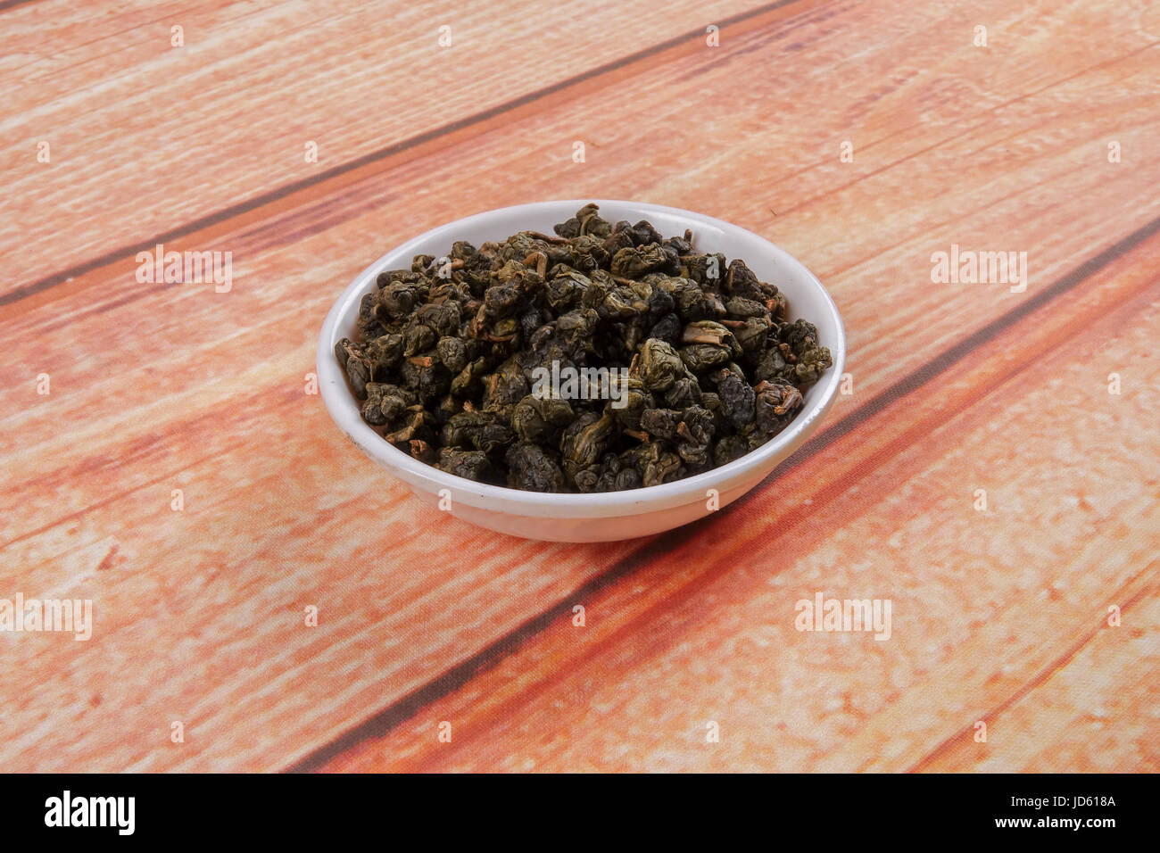 dried chinese tea leaves in a small bowl over wooden background Stock ...