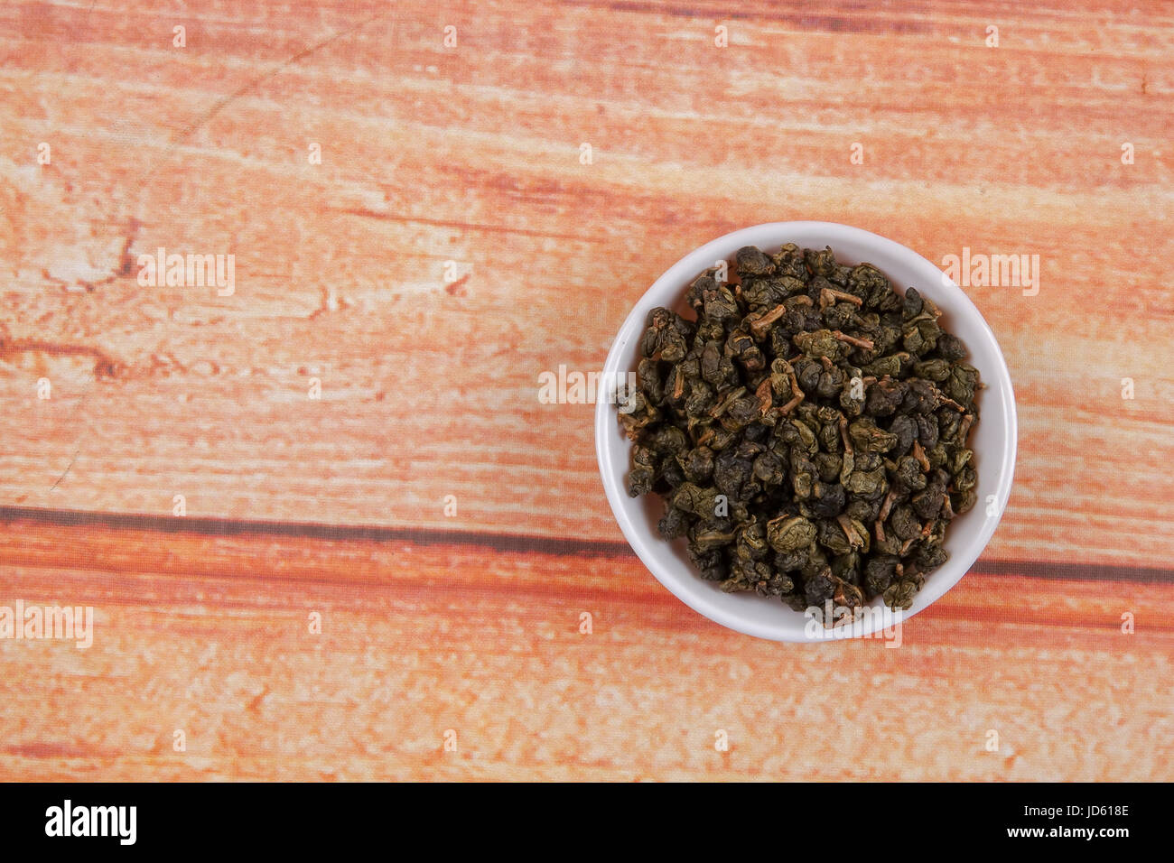 dried chinese tea leaves in a small bowl over wooden background Stock ...