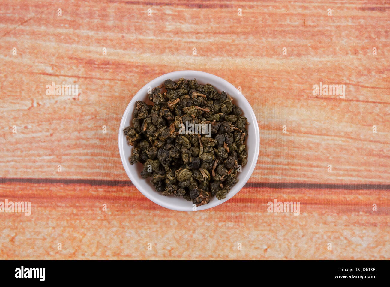 dried chinese tea leaves in a small bowl over wooden background Stock ...