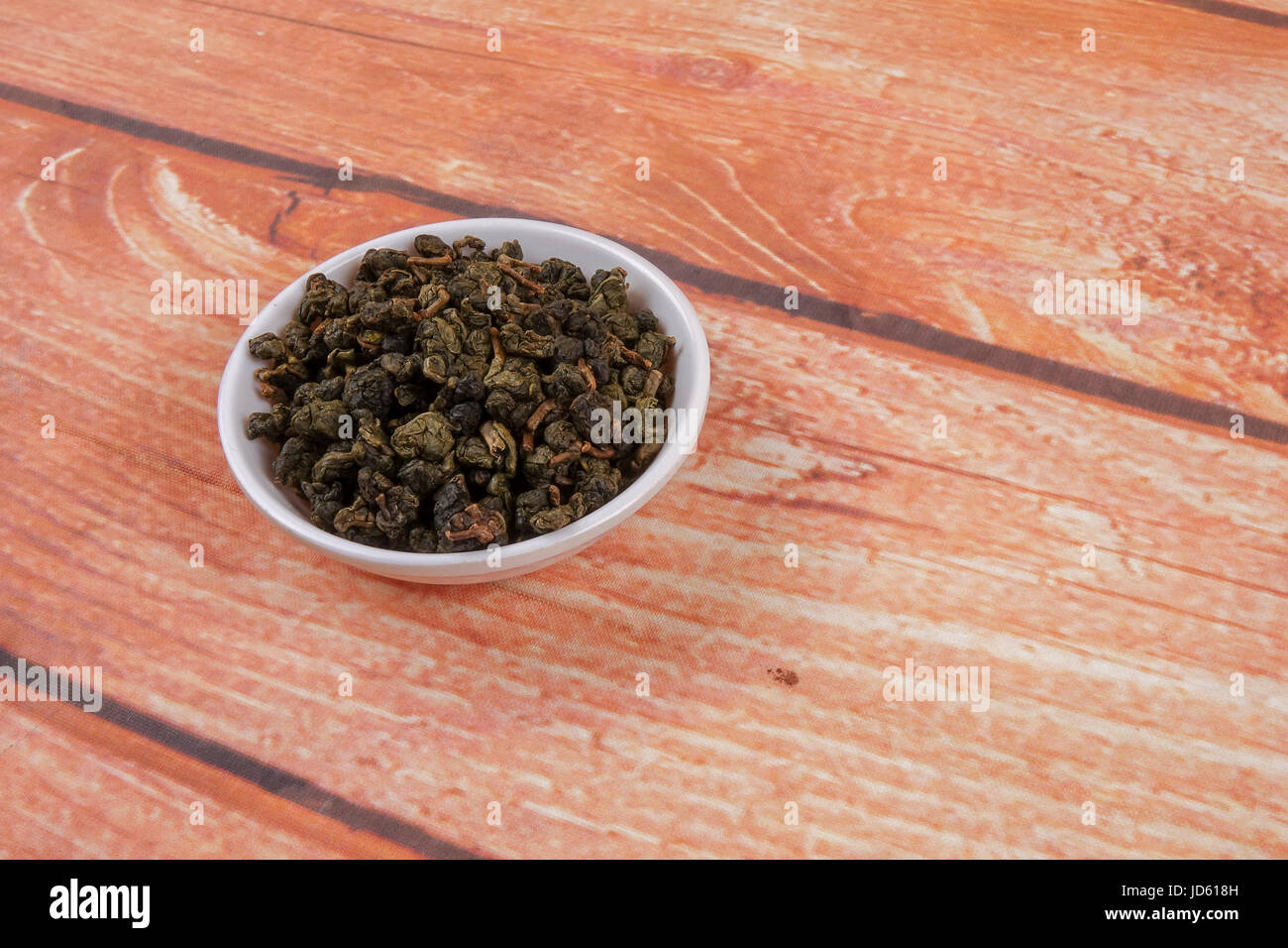 dried chinese tea leaves in a small bowl over wooden background Stock ...