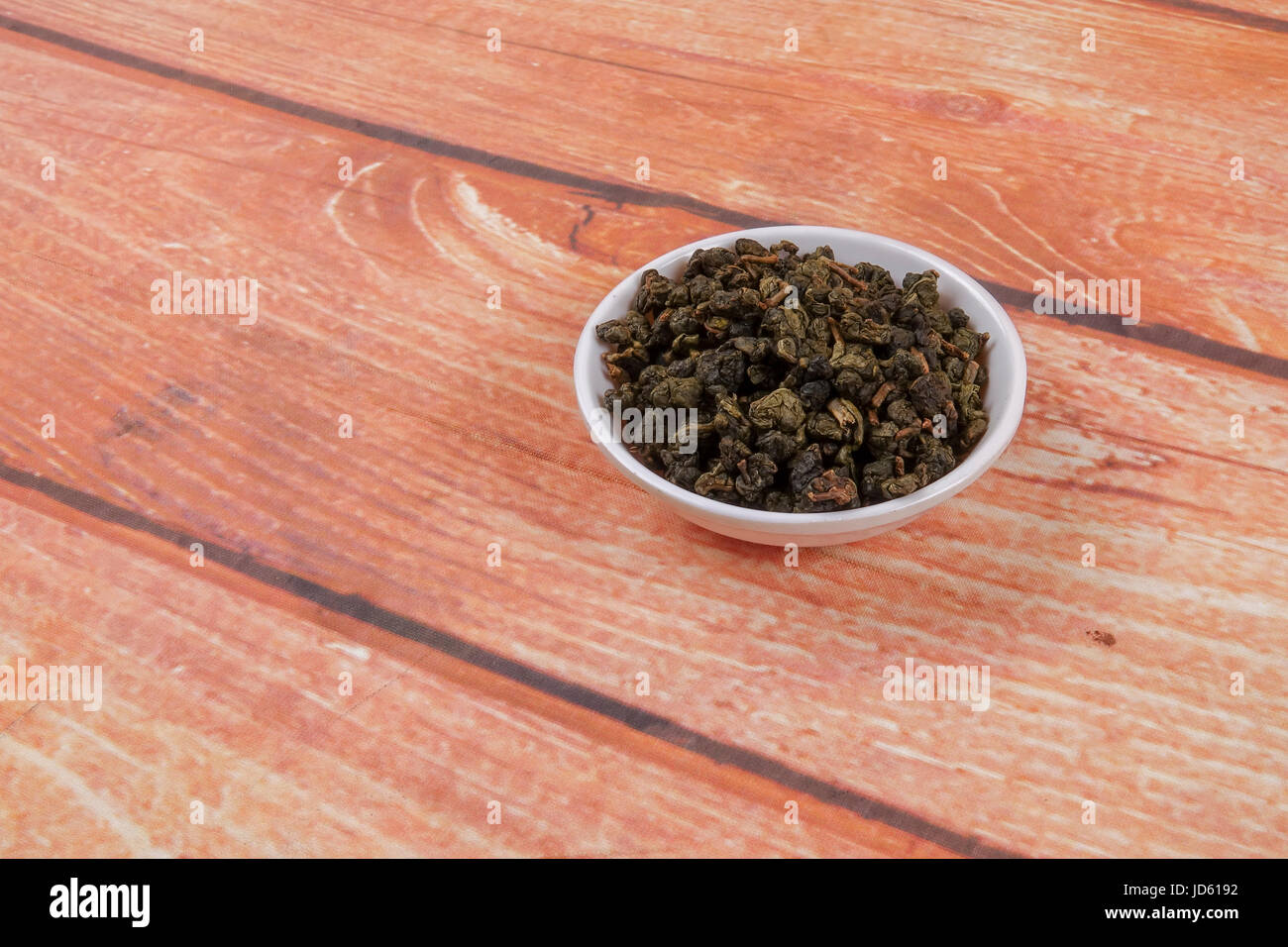 dried chinese tea leaves in a small bowl over wooden background Stock ...