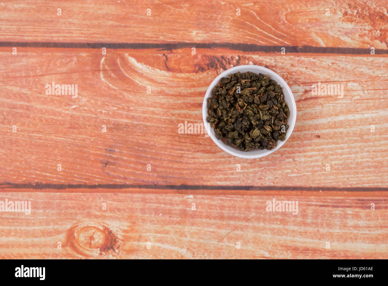 dried chinese tea leaves in a small bowl over wooden background Stock ...