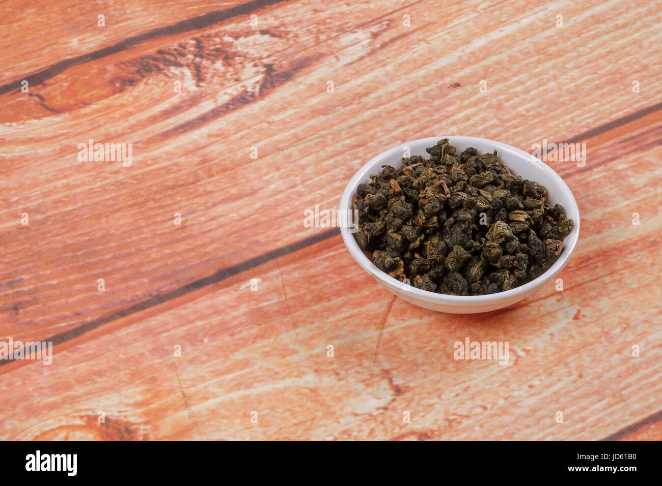dried chinese tea leaves in a small bowl over wooden background Stock ...