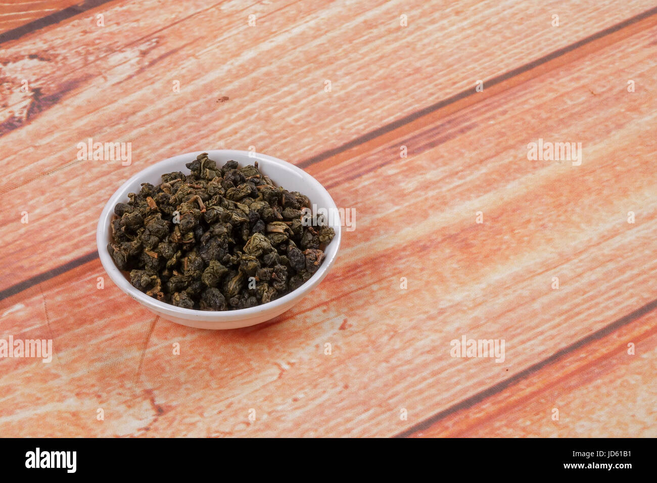 dried chinese tea leaves in a small bowl over wooden background Stock ...